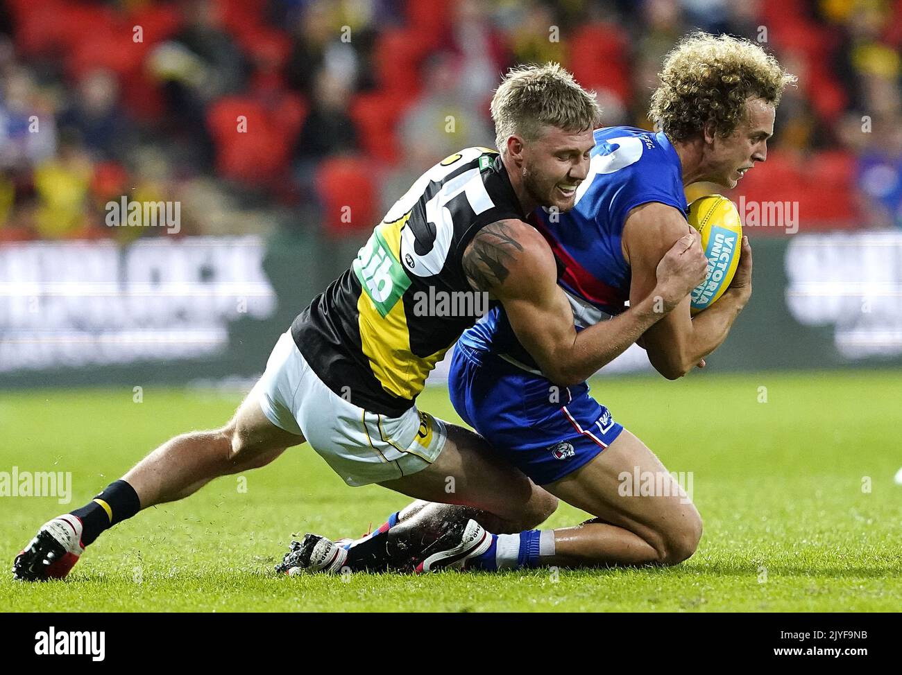 Mitch Wallis of the Bulldogs takes a mark ahead of Nathan Broad of the ...