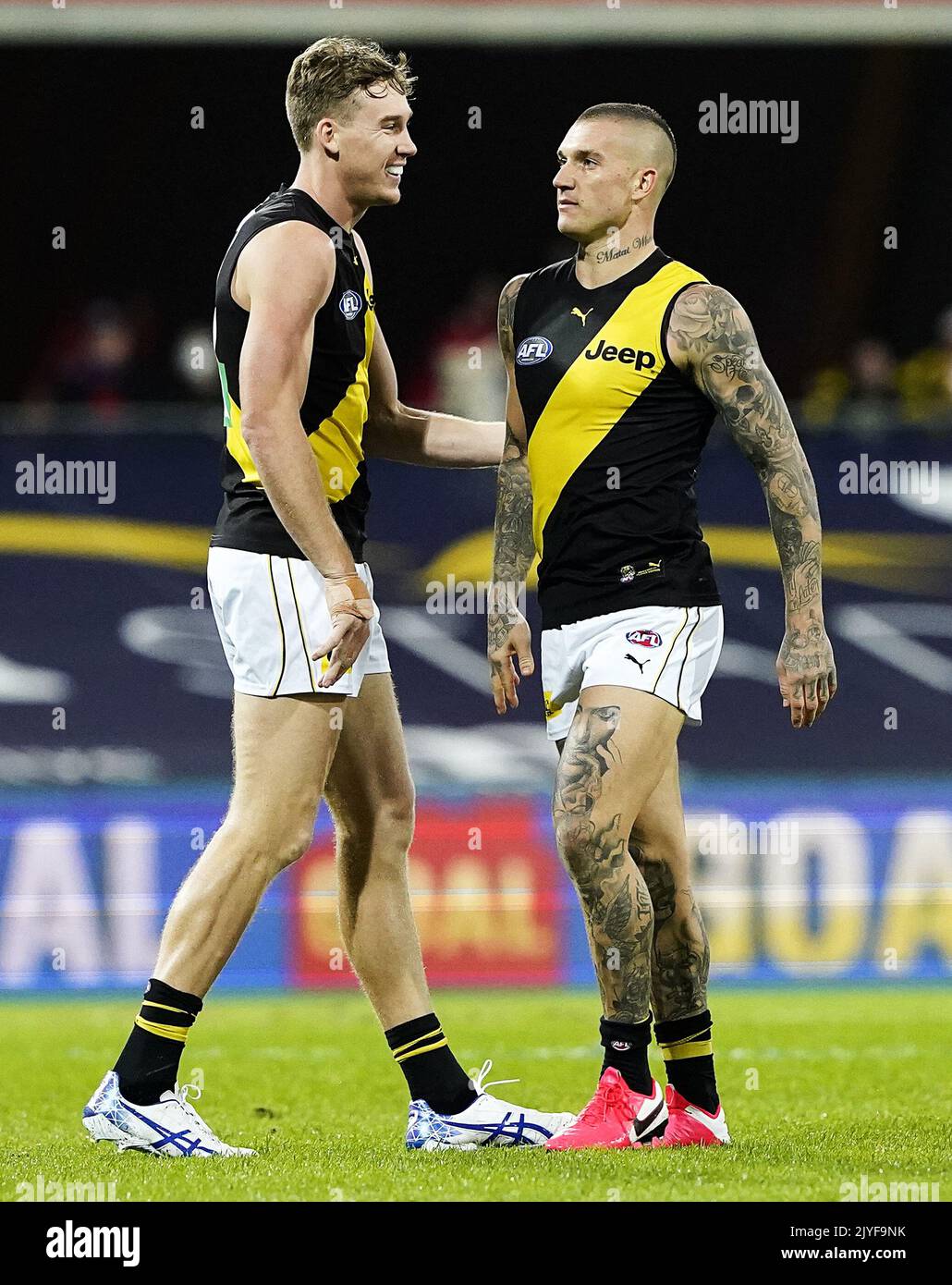 Tom Lynch of the Tigers (left) reacts with Dustin Martin after Martin ...