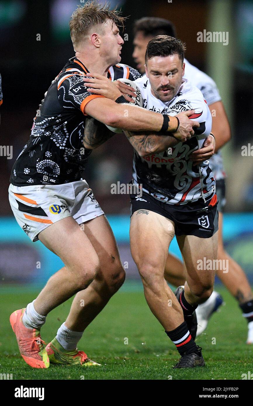 Wayde Egan of the Warriors is tackled by Luke Garner of the Tigers ...