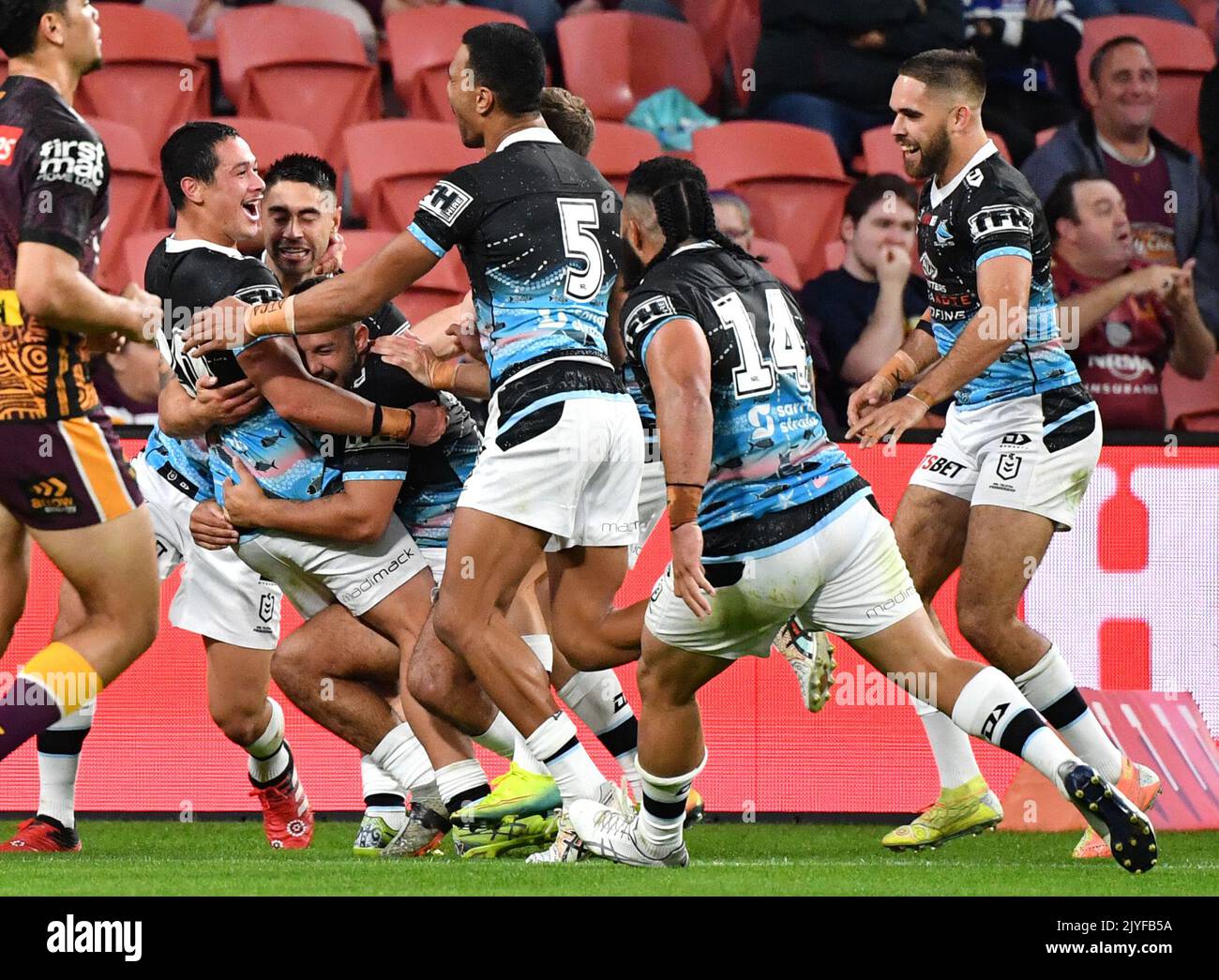 Jackson Ferris (left) of the Sharks celebrates scoring a try with team ...
