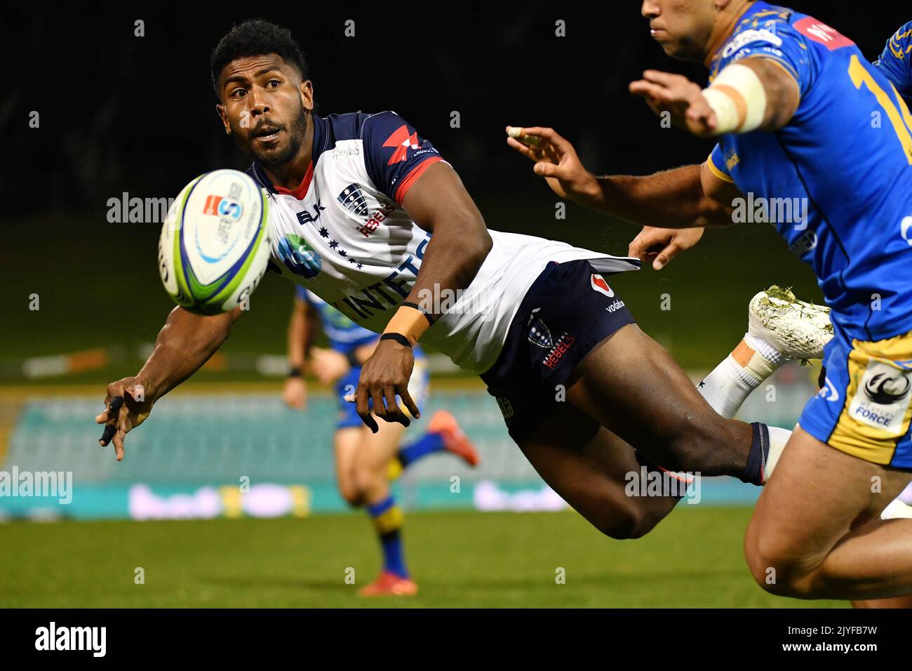Frank Lomani of the Rebels off loads after making a break during the ...