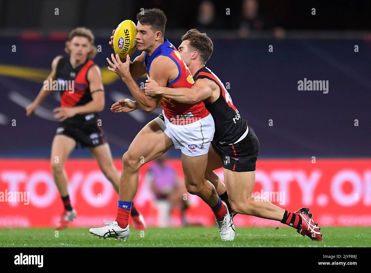 Brandon Starcevich of the Lions is tackled during the Round 9 AFL match ...