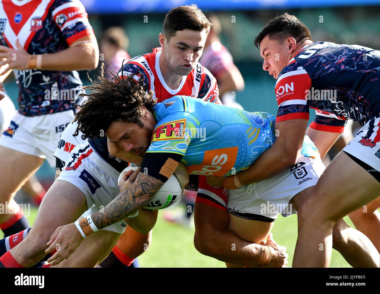 Kevin Proctor of the Titans is tackled by Kyle Flanagan (left) and ...
