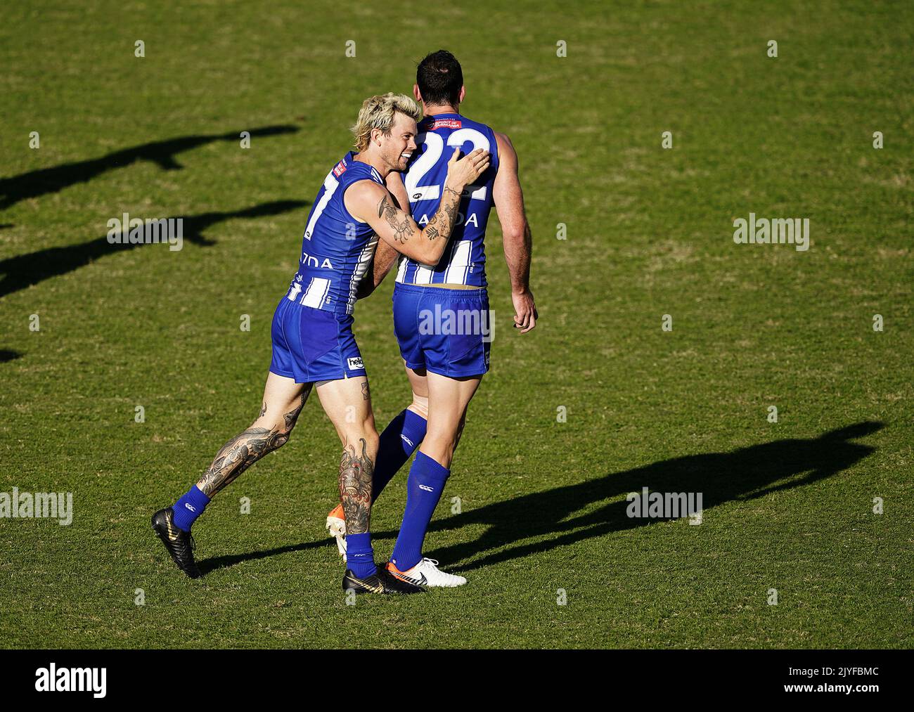 Jasper Pittard of the Kangaroos (left) reacts with Todd Goldstein after ...