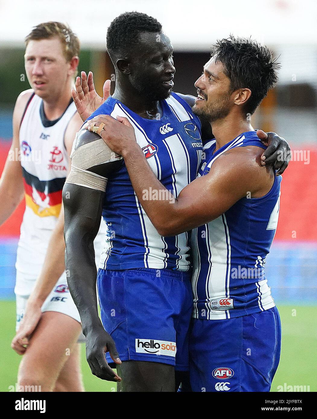 Majak Daw of the Kangaroos reacts with Aaron Hall (right) following the ...