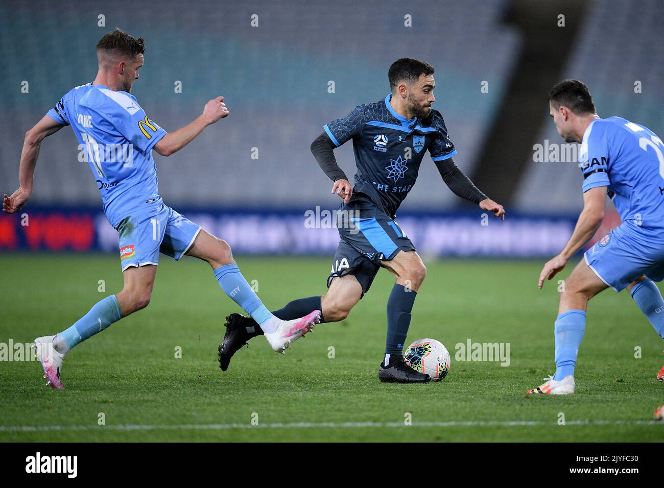 Anthony Caceres of Sydney competes for possession with Craig Noone of ...