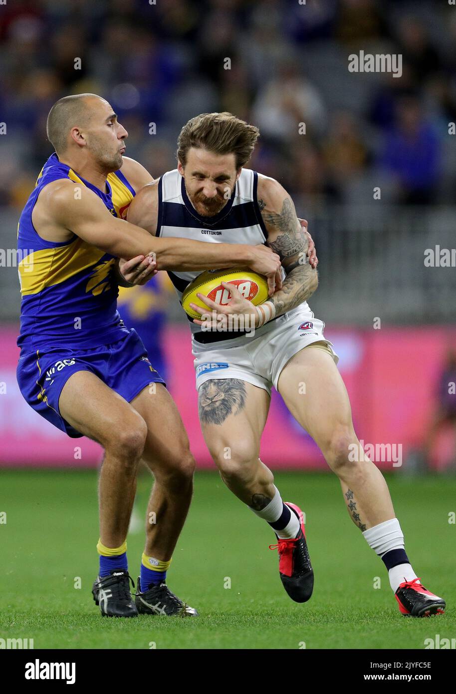 Zach Tuohy of the Cats is tackled by Dom Sheed of the Eagles during the ...
