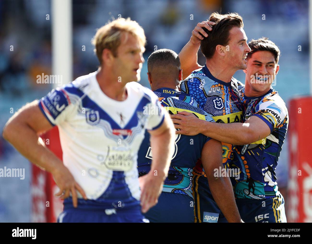Clint Gutherson of the Eels celebrates scoring a try with team mates ...