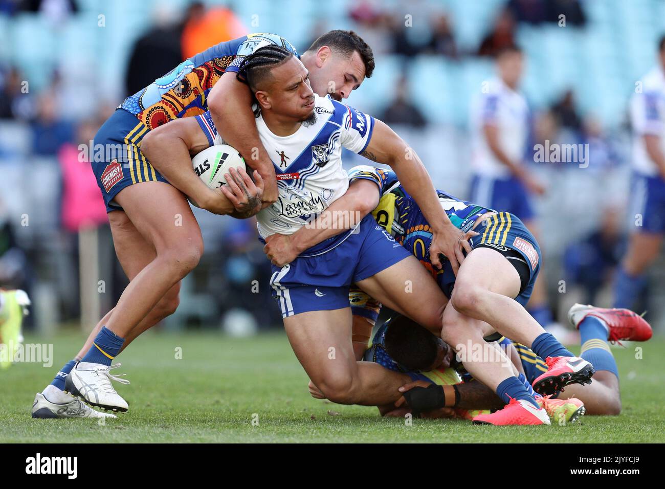Sauaso Sue of the Bulldogs is tackled by the Eels defence during the ...