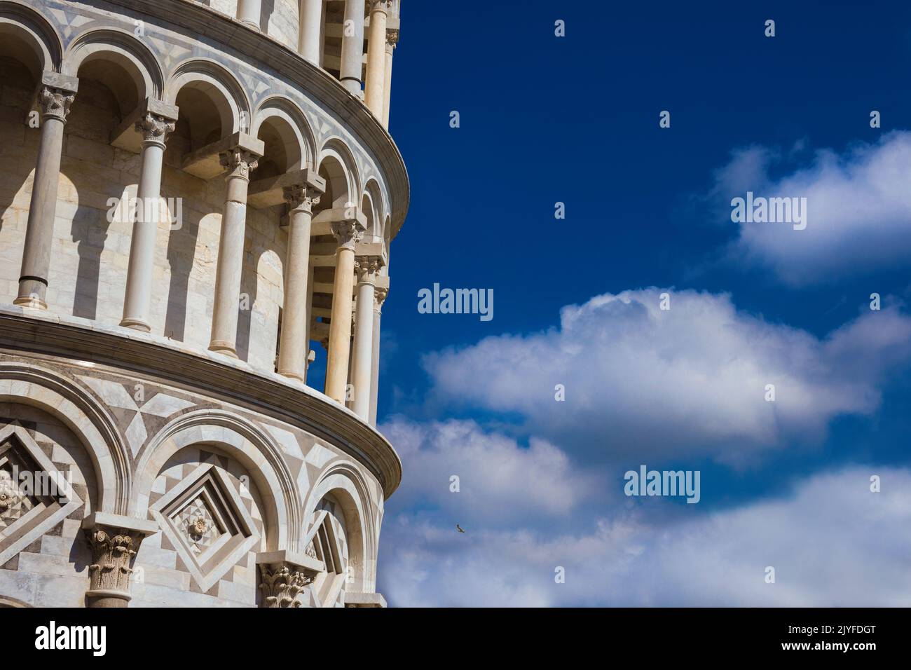 The famous Leaning Tower of Pisa monumental arches with blue sky and ...