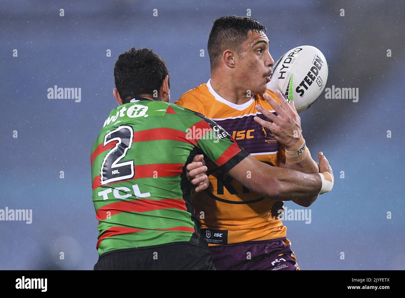 Kotoni Staggs of the Broncos (right) is tackled by Alex Johnston of the ...
