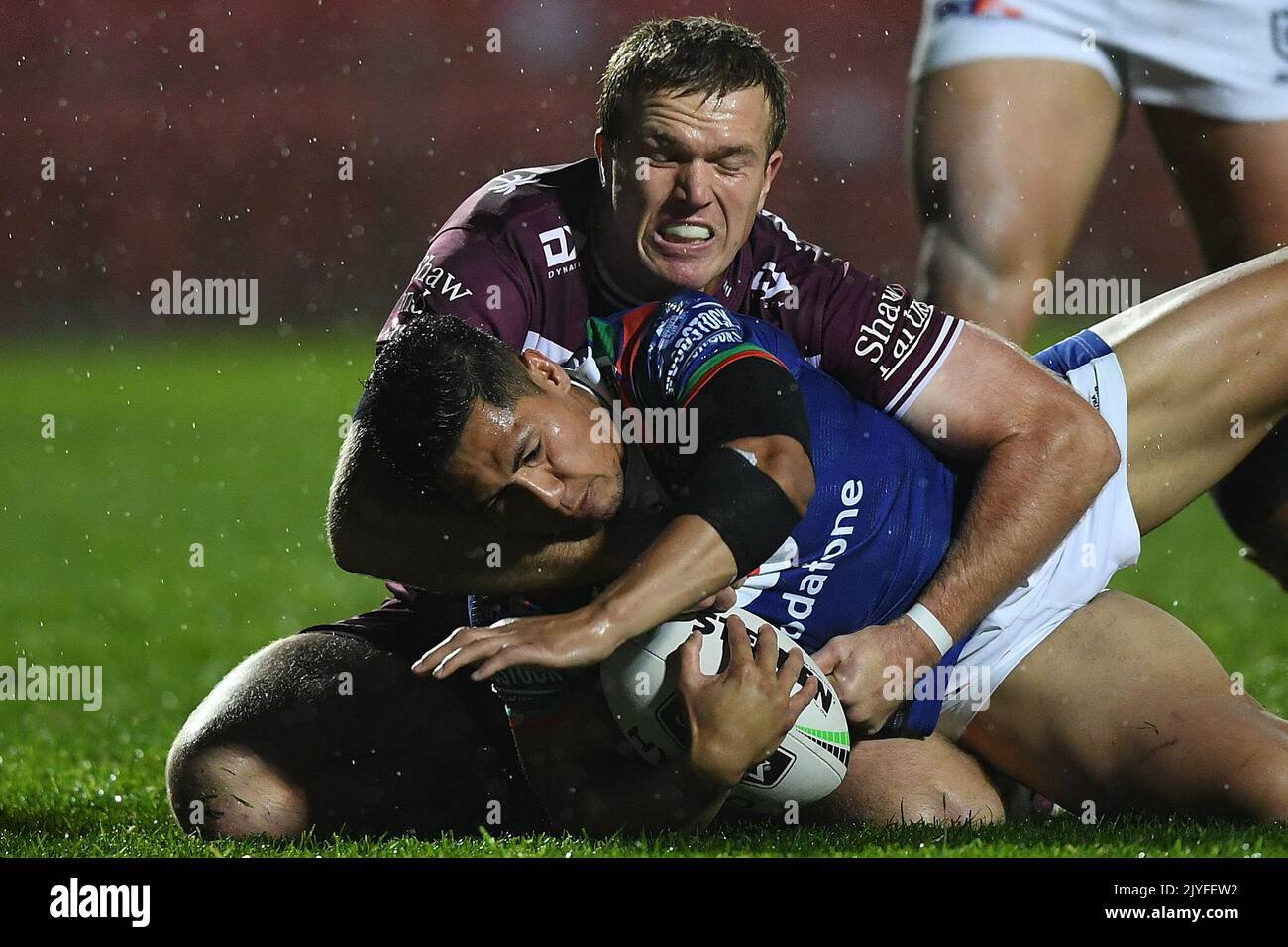 Jake Trbojevic of the Sea Eagles tackles Roger Tuivasa-Sheck of the ...
