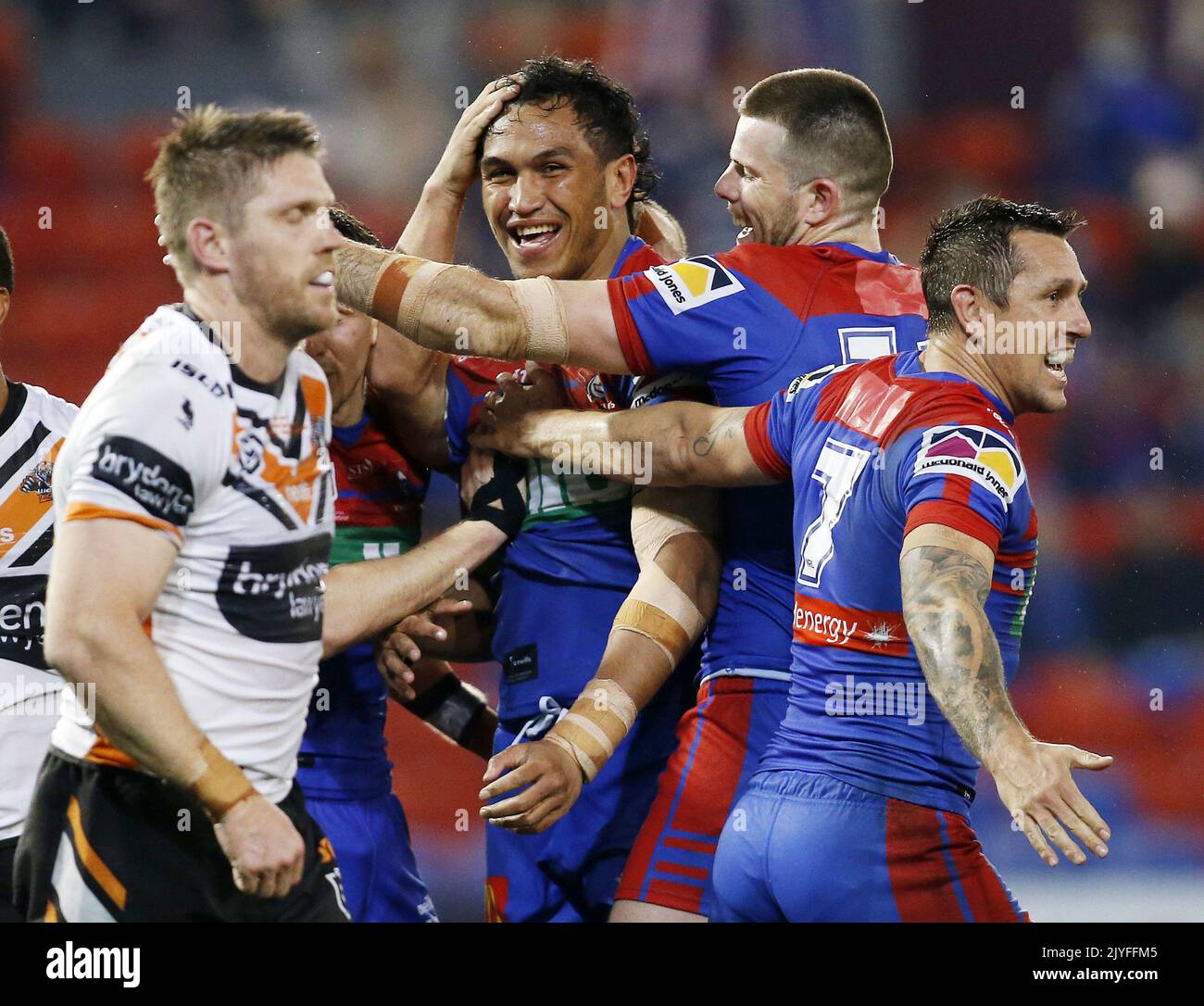 Jacob Saifiti of the Knights celebrates scoring a first half try during ...