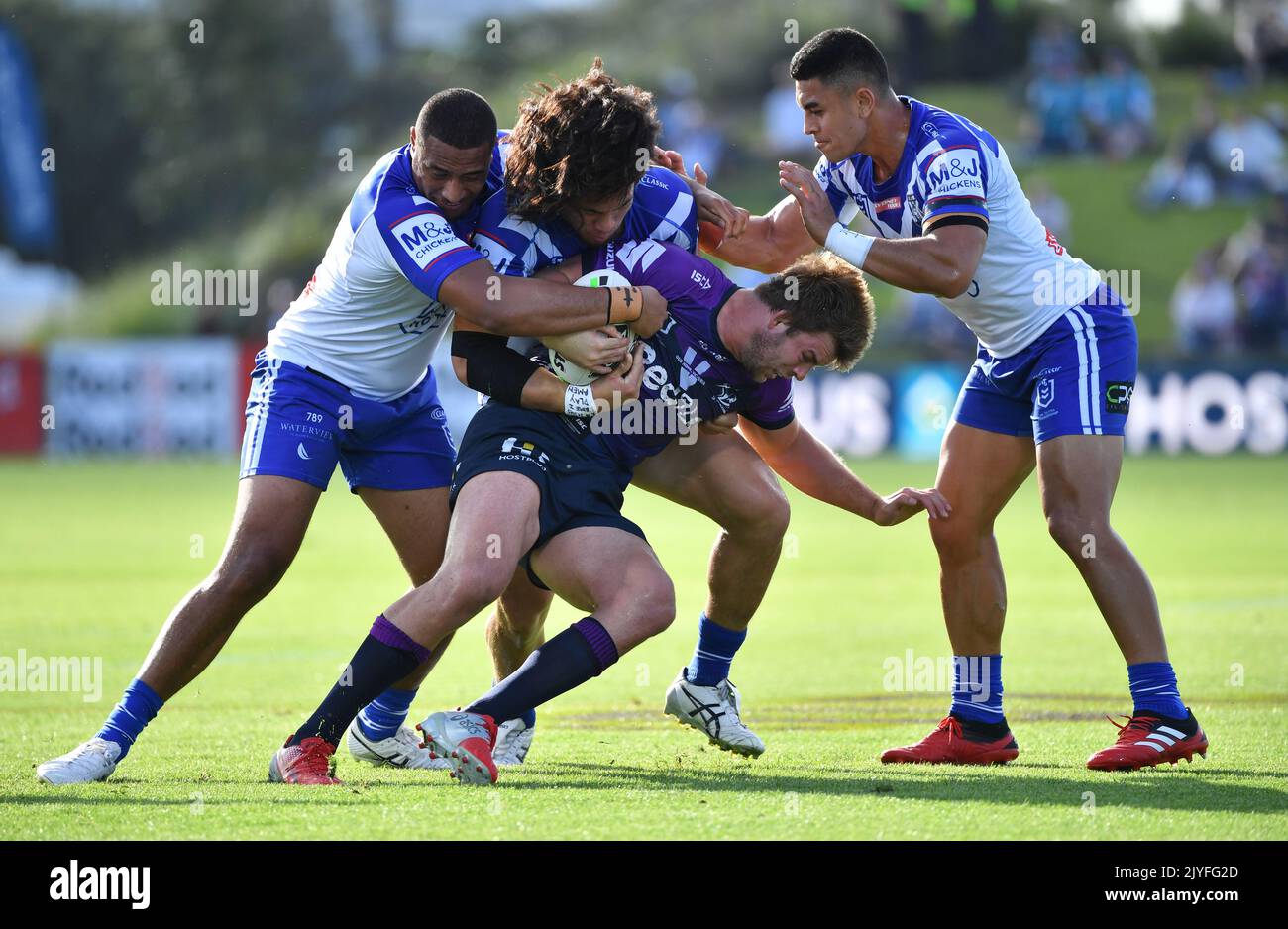 Christian Welch (centre) of the Storm runs into the Bulldogs defence ...