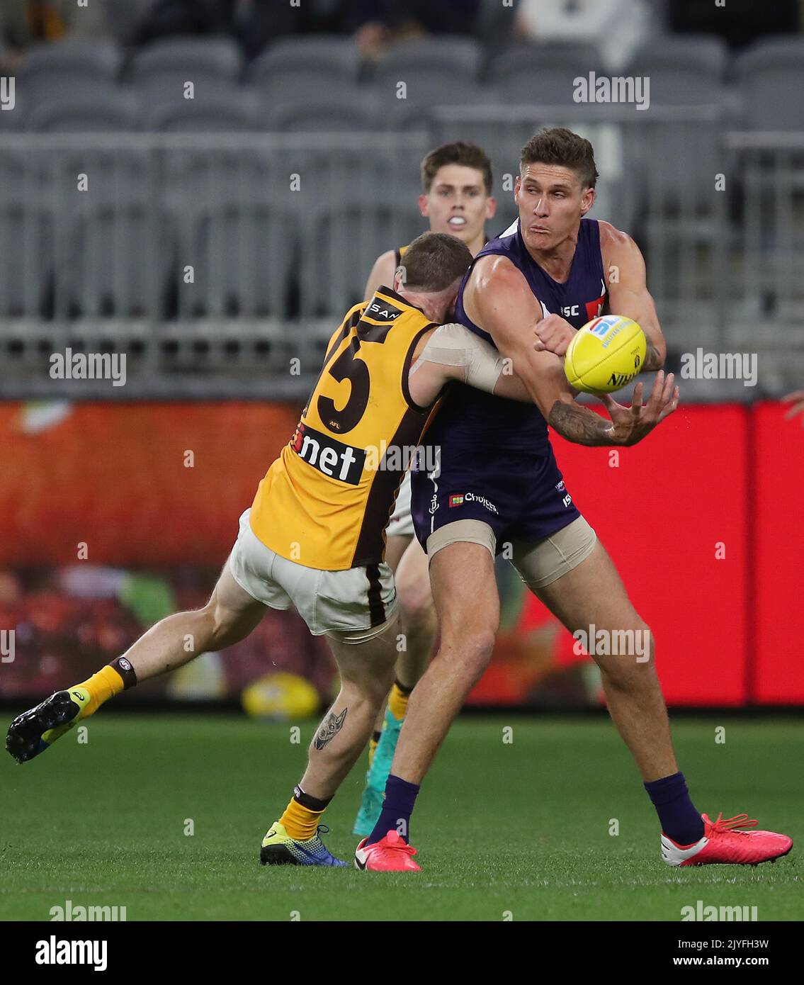 Rory Lobb of the Dockers looks for a hand pass under pressure from ...