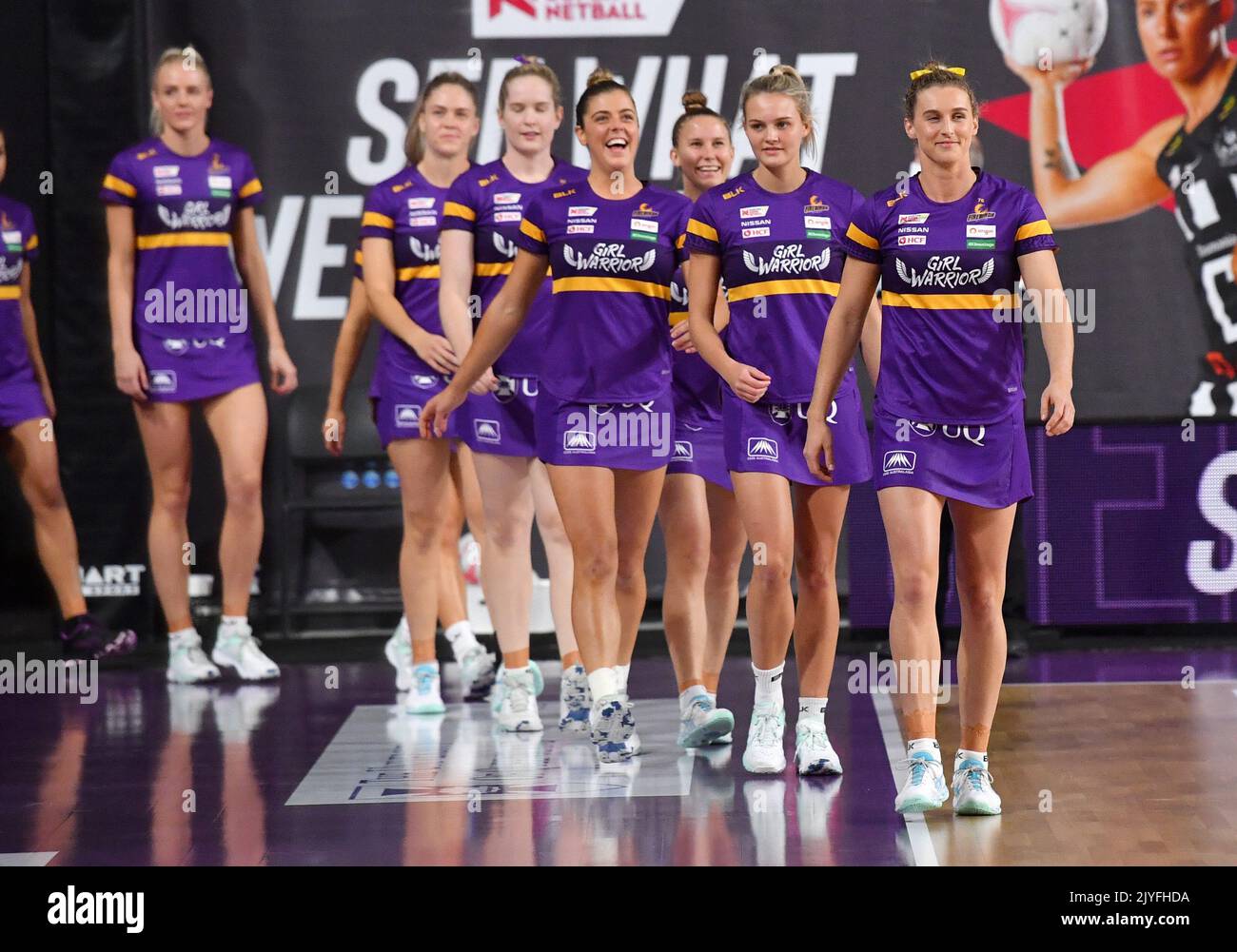 Gabi Simpson (right) of the Firebirds is seen leading her team out ...