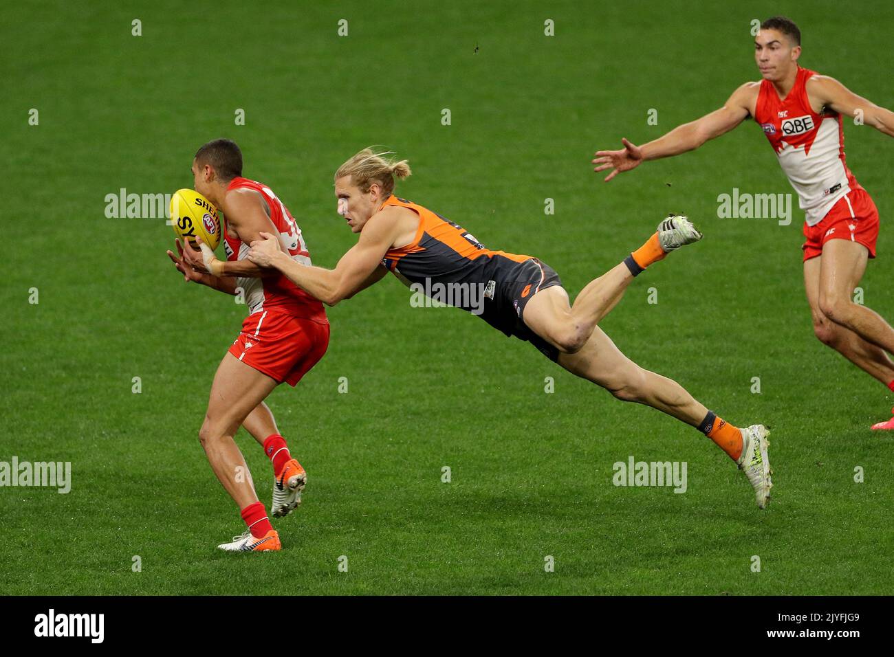 Nick Haynes of the Giants tackles James Bell of the Swans during round ...
