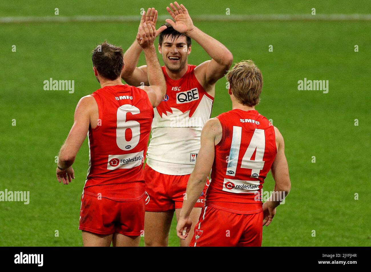 Swans players celebrate after winning the round 12 AFL match between ...