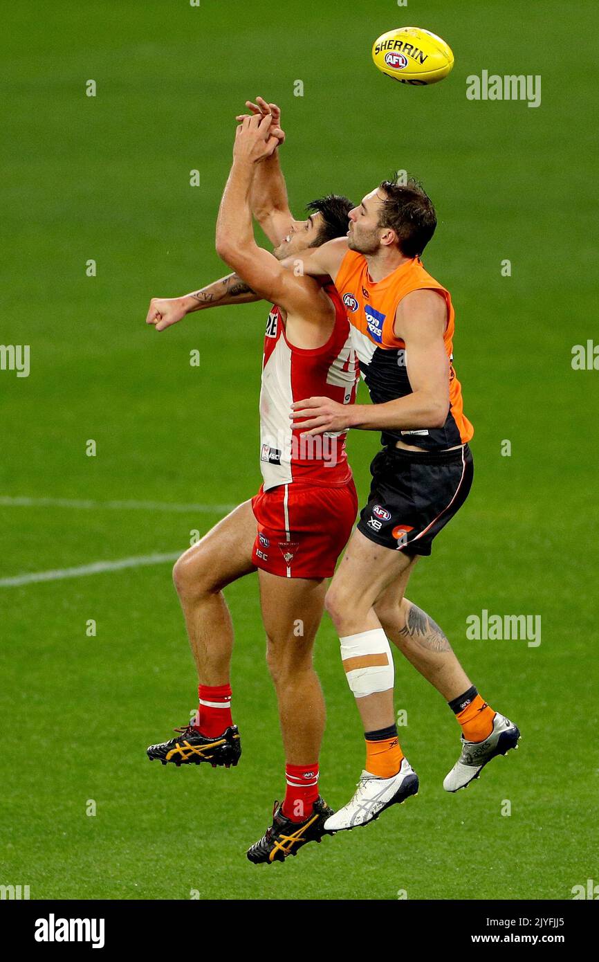 Lewis Melican of the Swans and Jeremy Finlayson of the Giants compete ...