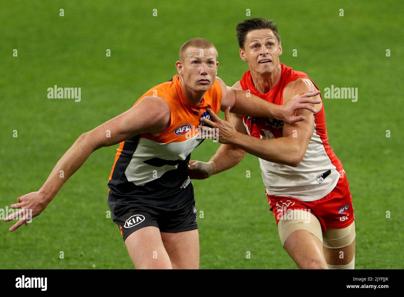 Sam Jacobs of the Giants and Callum Sinclair of the Swans compete for ...