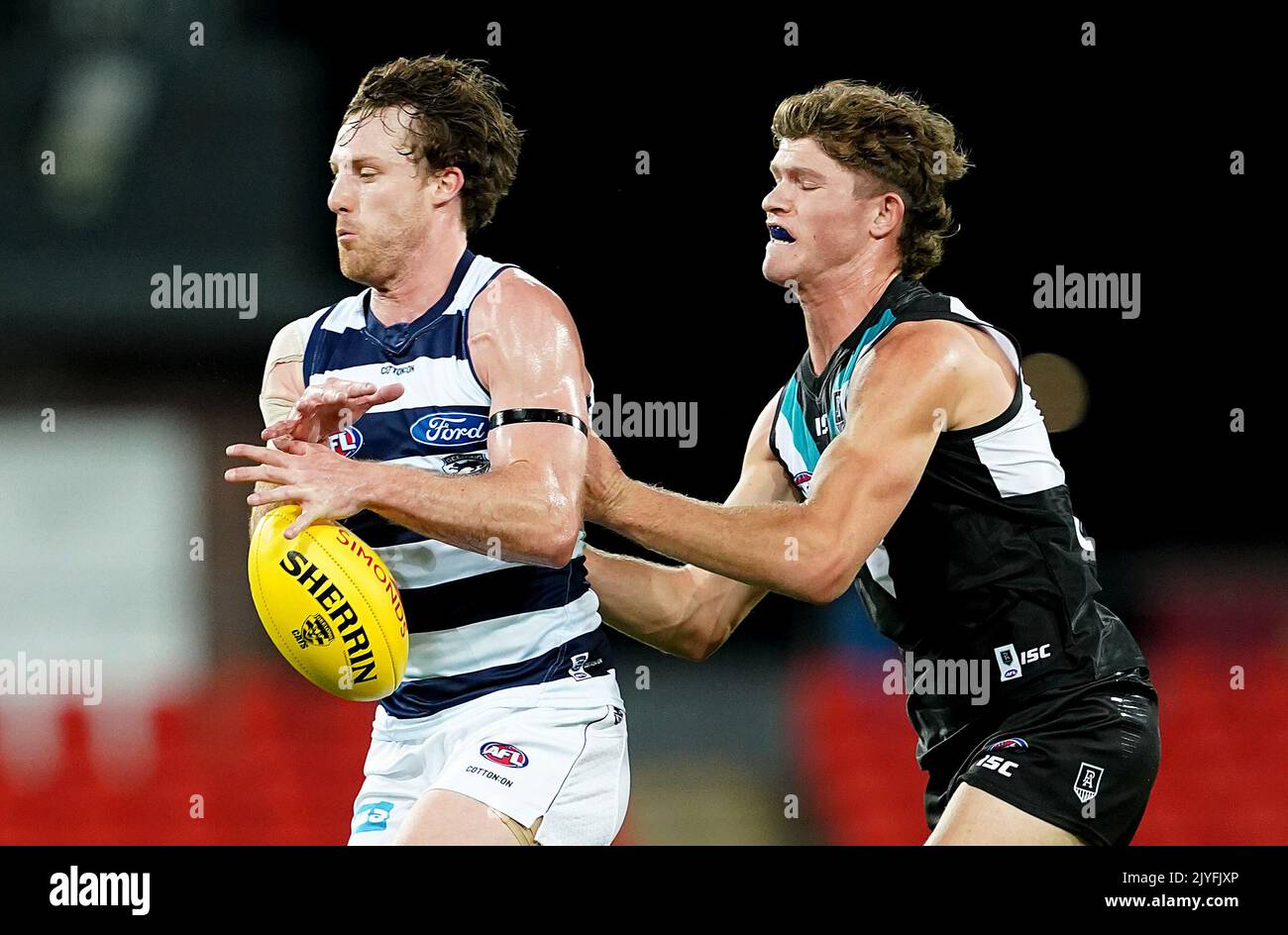 Jed Bews of the Cats (left) and Mitchell Georgiades of the Power during ...