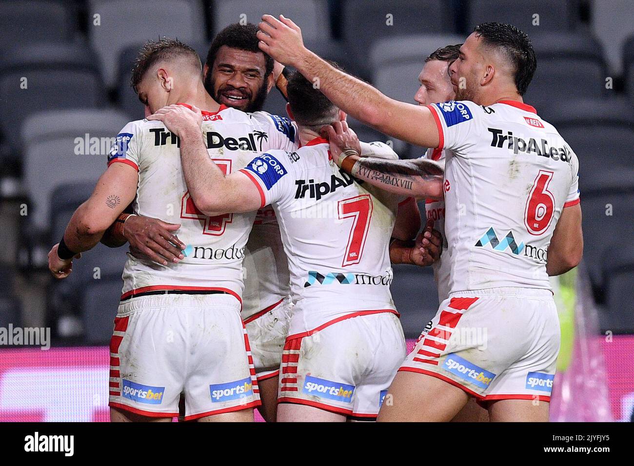 Mikaele Ravalawa of the Dragons (second left) celebrates with teammates ...