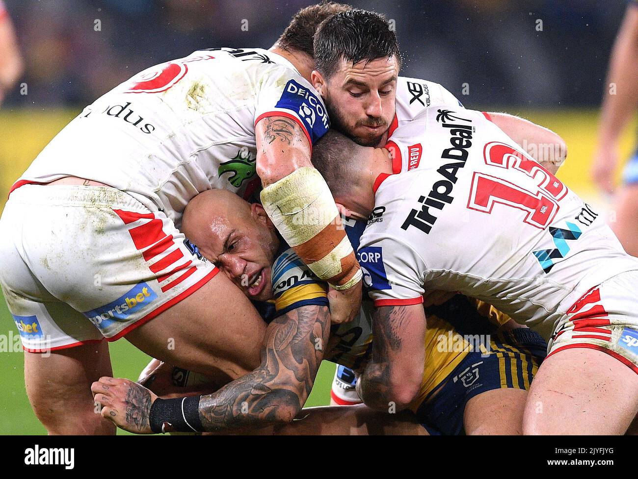 Blake Ferguson of the Eels is tackled by Korbin Sims (left) Ben Hunt ...