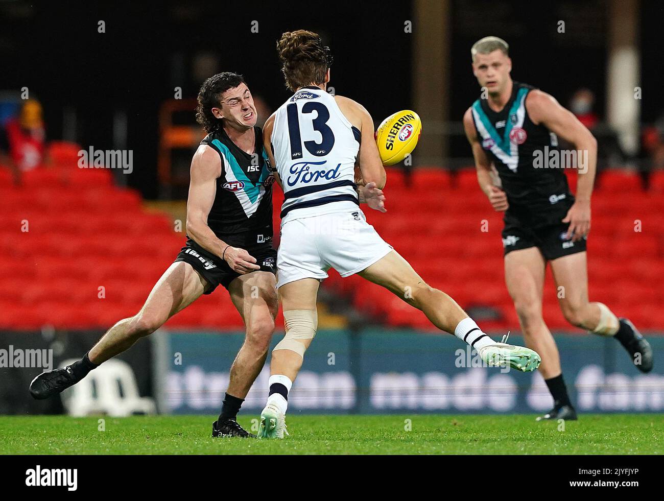 Darcy Byrne-Jones of the Power (left) tackles Lachie Fogarty of the ...