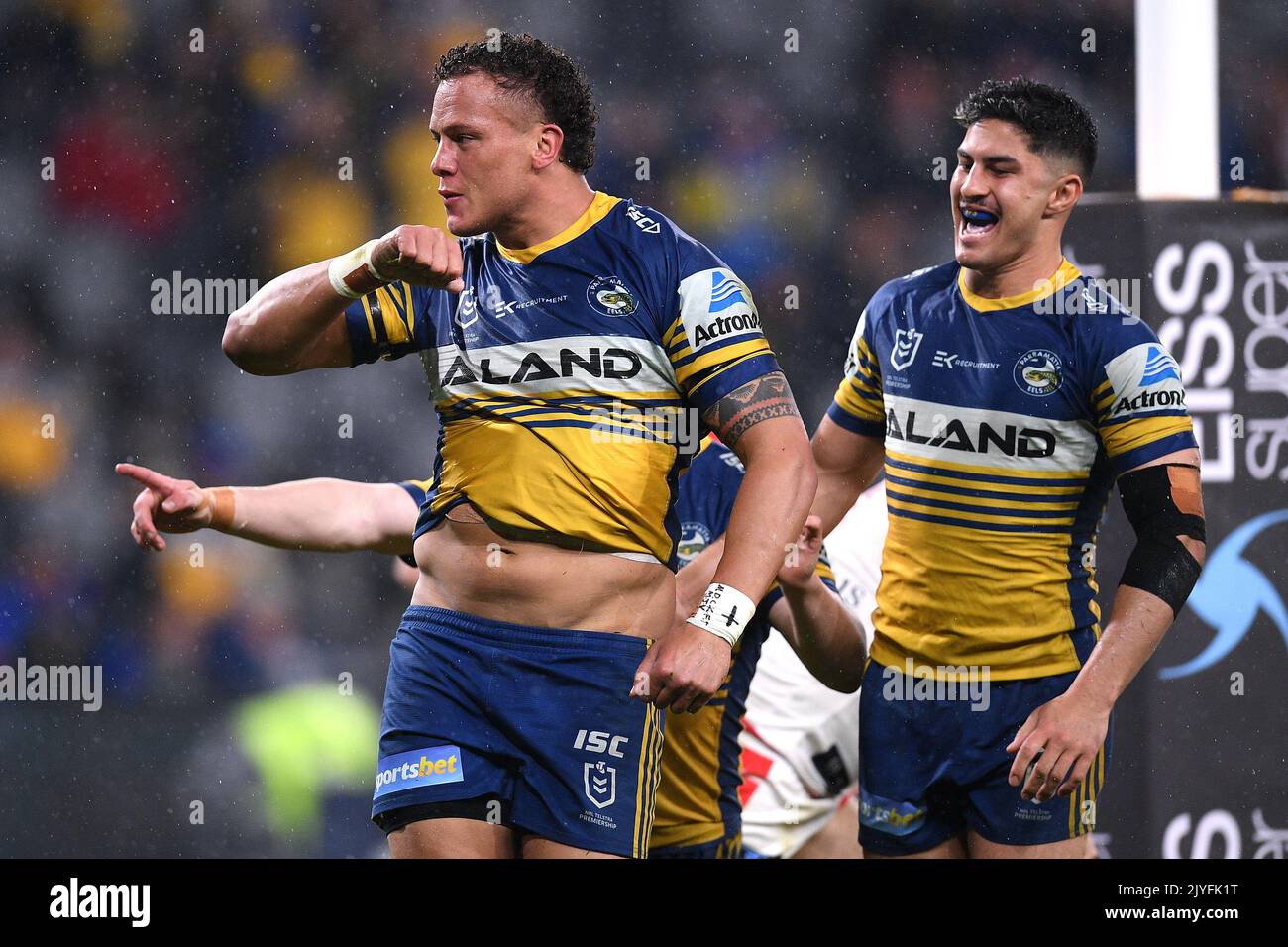 Kane Evans of the Eels (left) celebrates after scoring a try during the ...