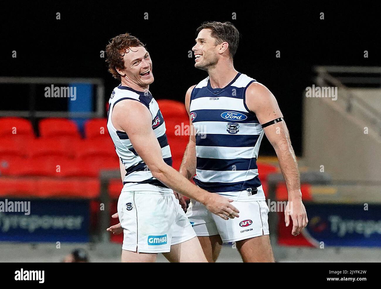 Cats players Gary Rohan (left) and Tom Hawkins celebrate following a ...