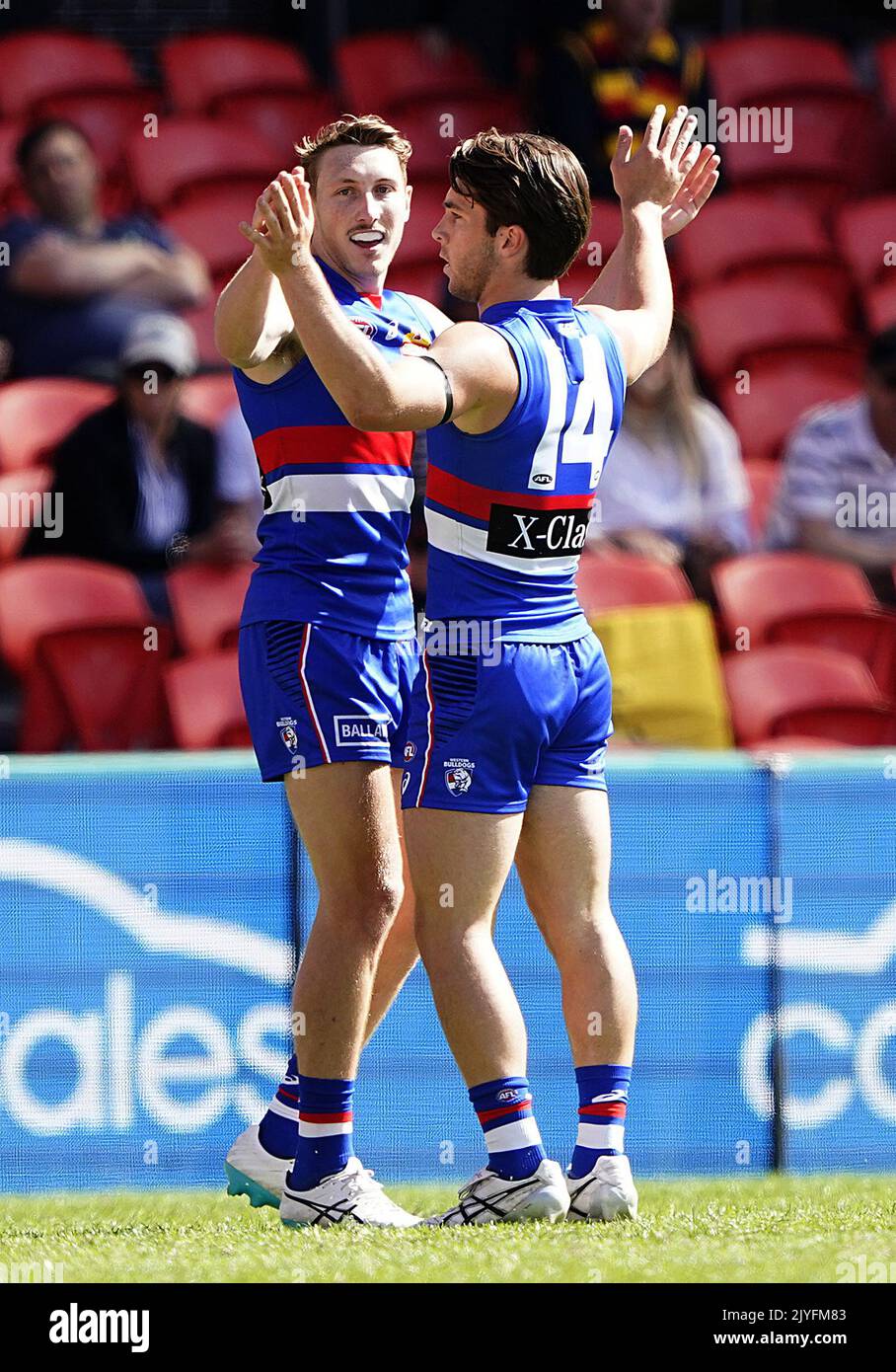 Bailey Dale of the Bulldogs (left) reacts after kicking a goal during ...