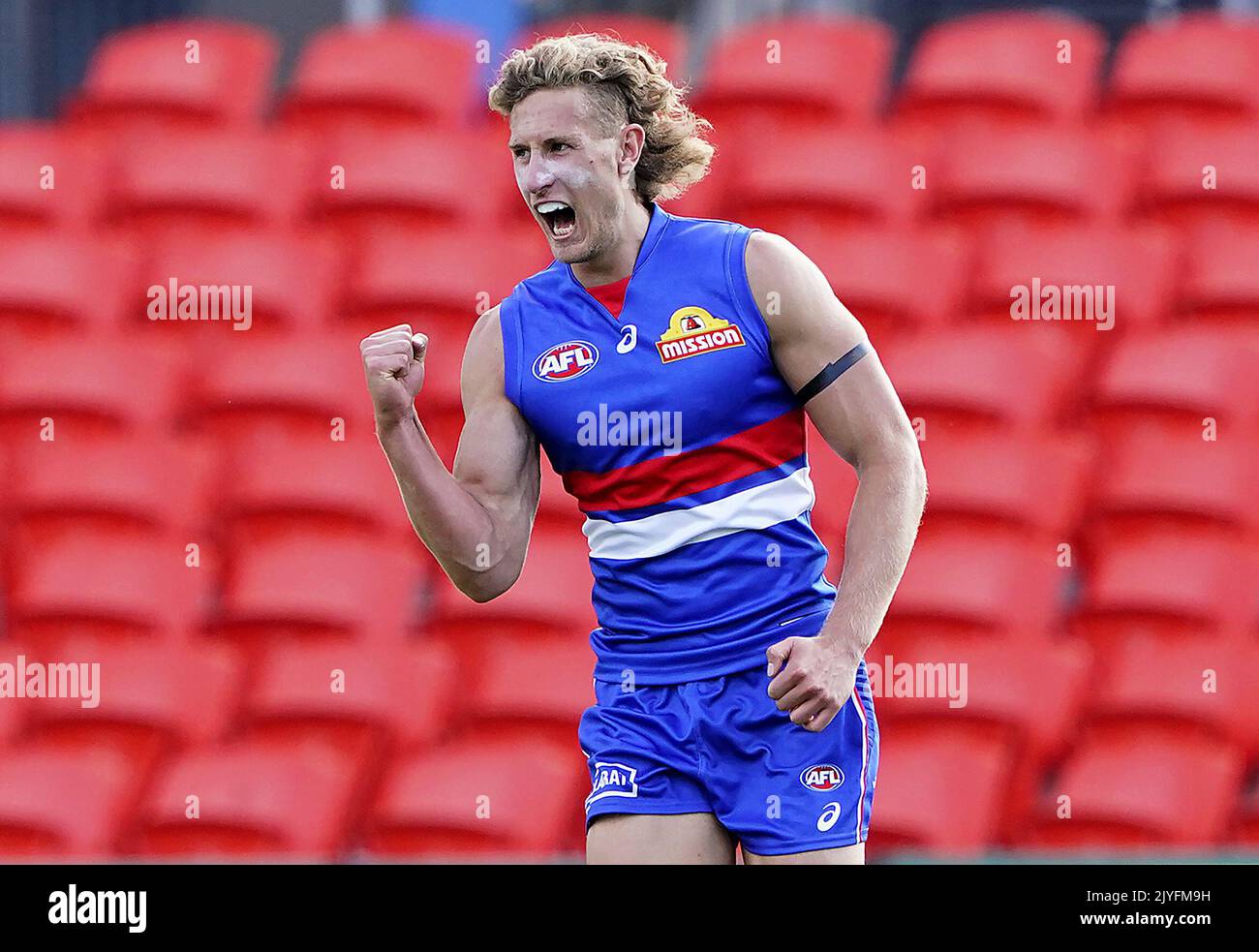 Aaron Naughton of the Bulldogs reacts after kicking a goal during the ...