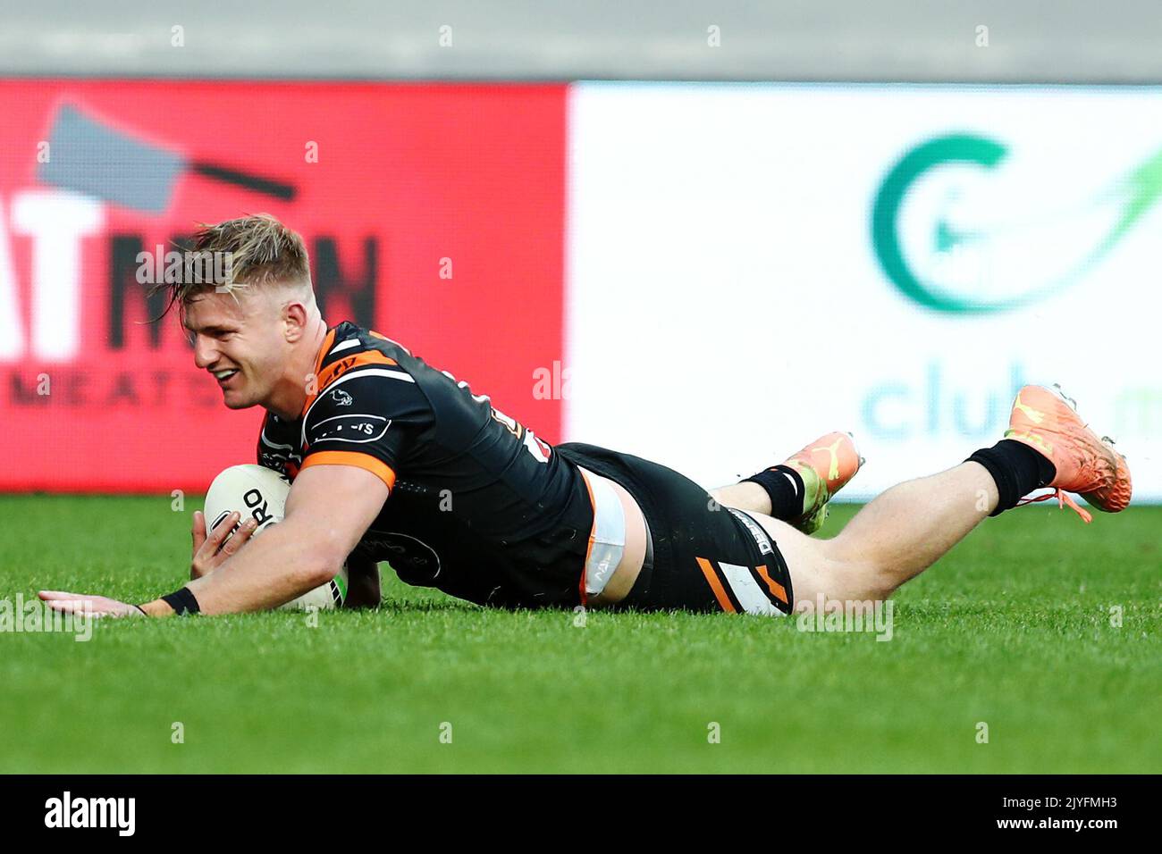 Luke Garner of the Tigers scores a try during the Round 14 NRL match ...