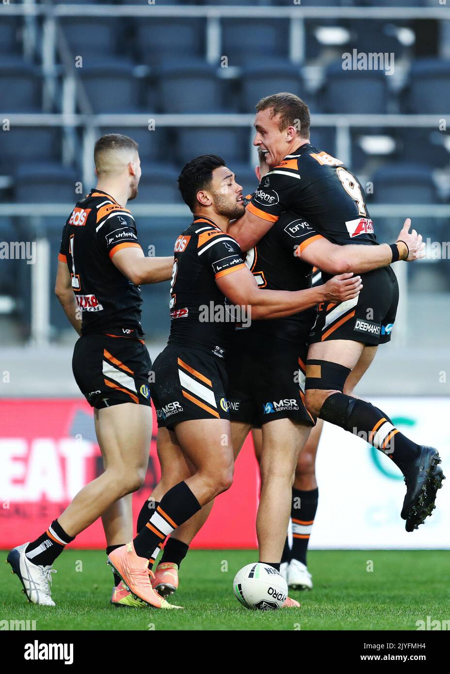 Luke Garner of the Tigers celebrates scoring a try with team mates ...