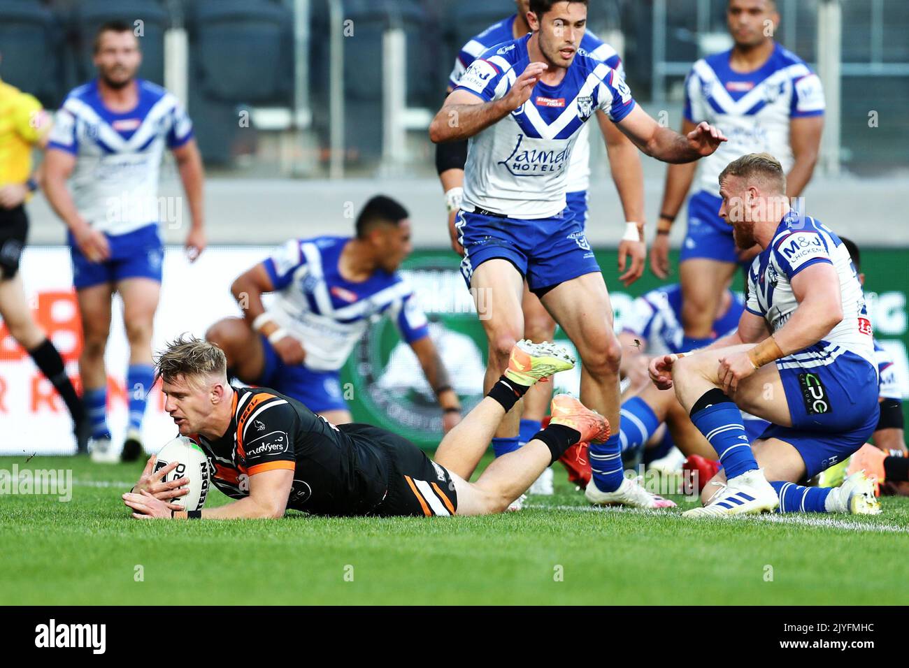 Luke Garner of the Tigers scores a try during the Round 14 NRL match ...
