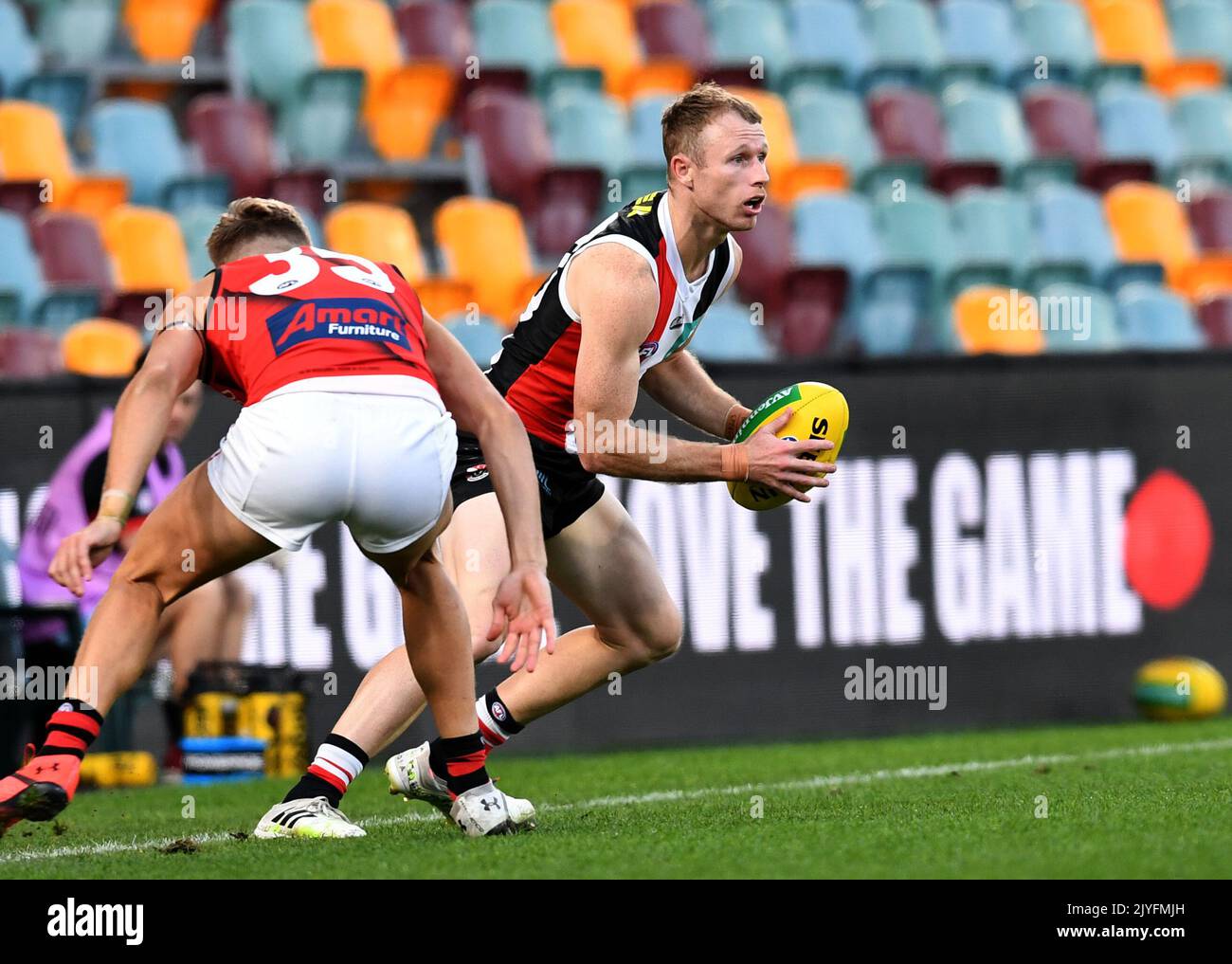 Nick Hind of the Saints (right) avoids Matt Guelfi of the Bombers ...