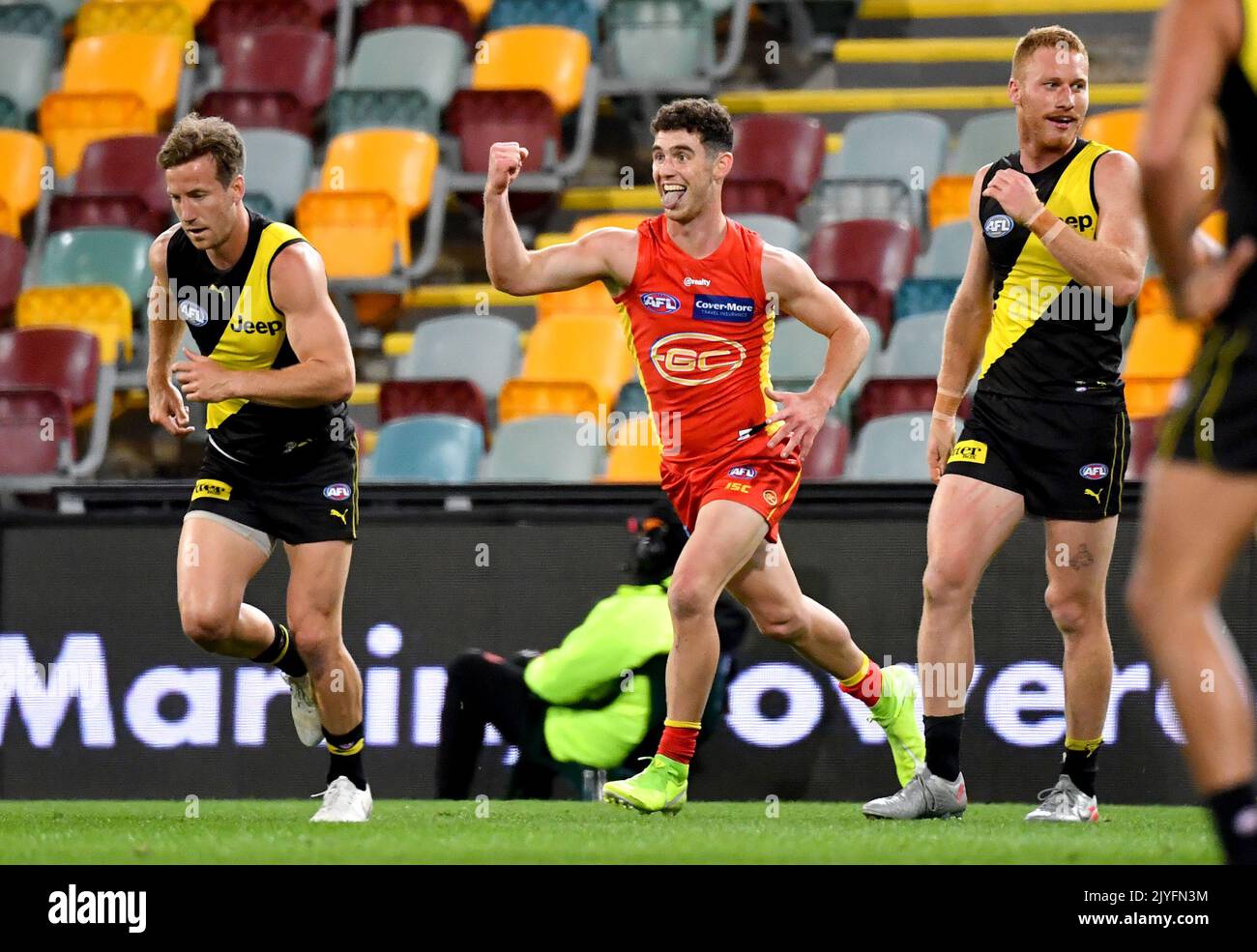 Sam Flanders (centre) of the Suns celebrates kicking a goal during the ...