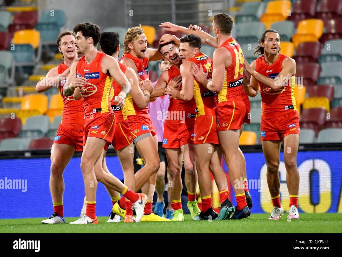 Sam Flanders (centre) of the Suns celebrates kicking a goal with team ...