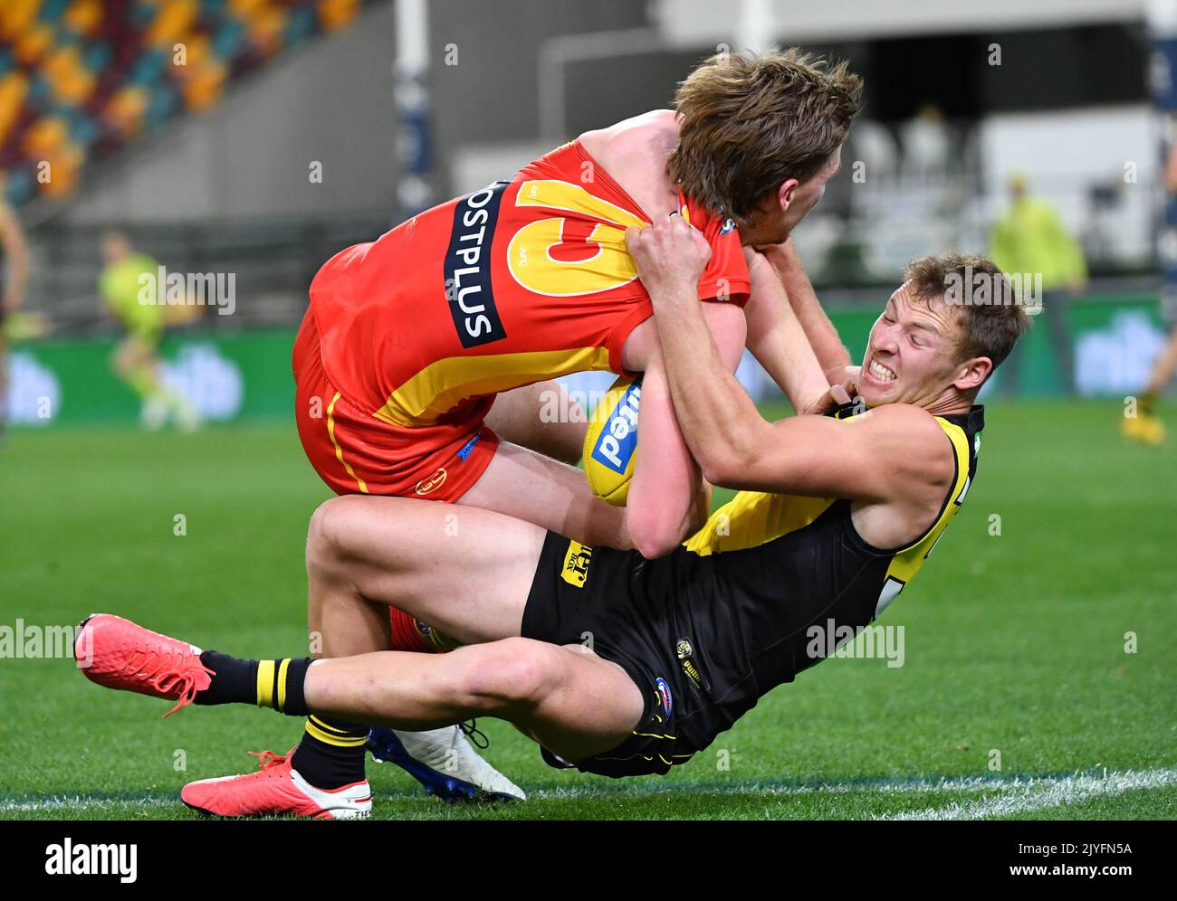 Noah Anderson (left) of the Suns is tackled by Jake Aarts (right) of ...