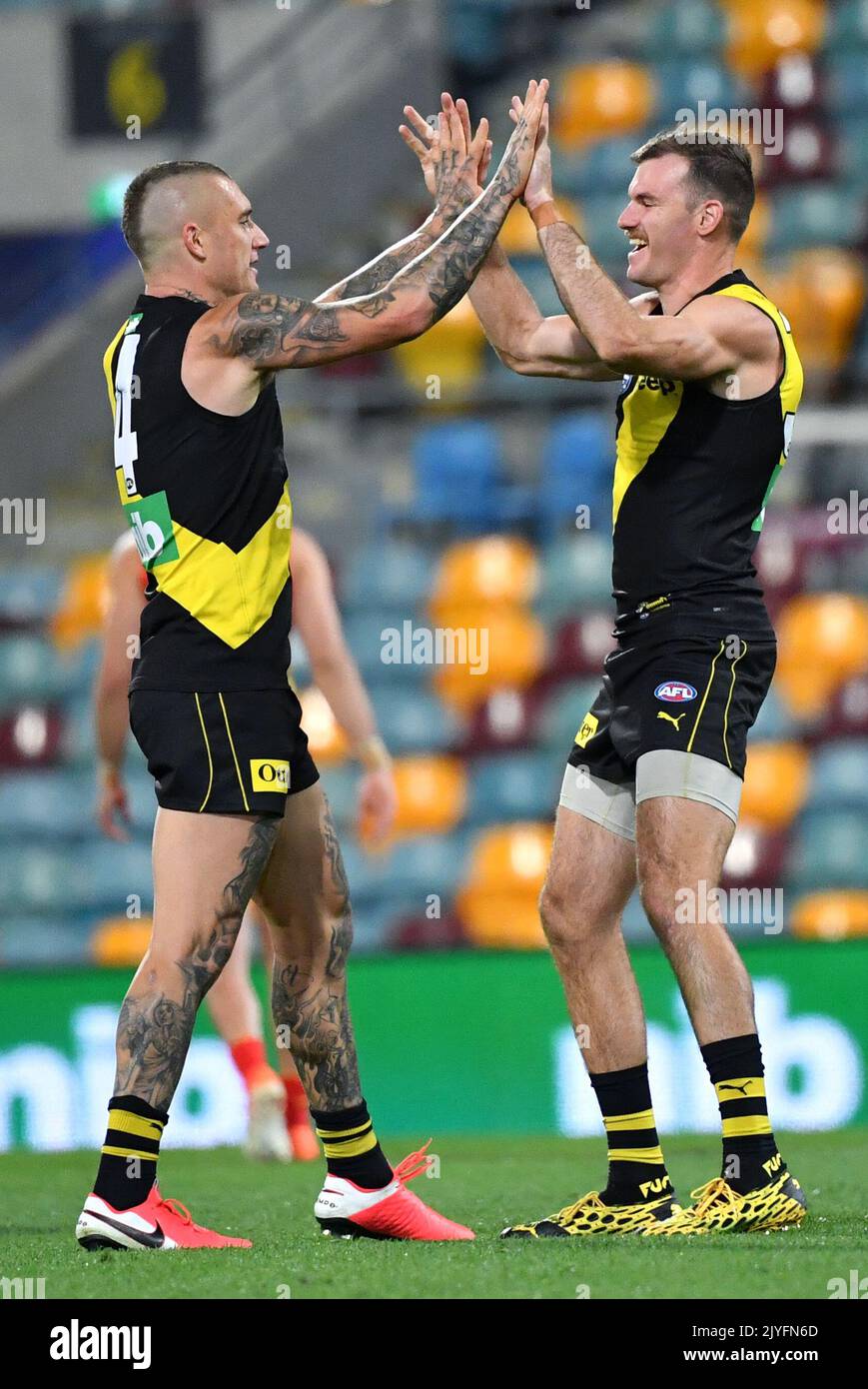 Kamdyn McIntosh (right) of the Tigers celebrates kicking a goal with ...