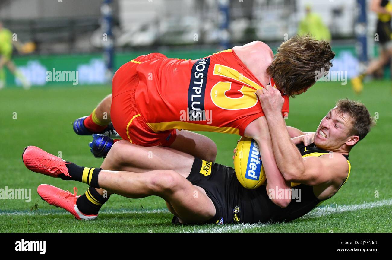 Noah Anderson (left) of the Suns is tackled by Jake Aarts (right) of ...