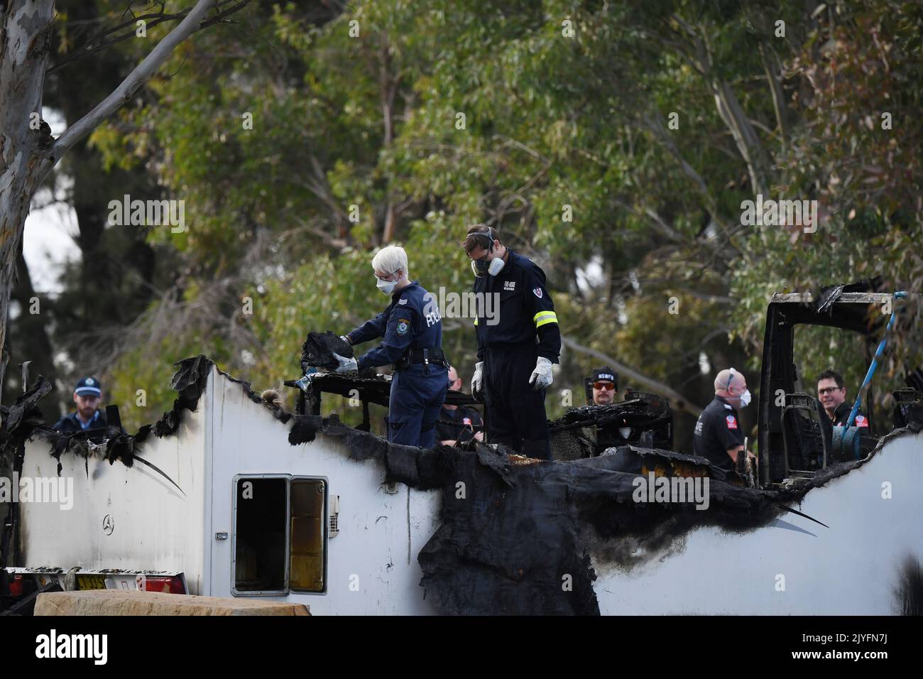 NSW Police and Forensic officers at the scene of a campervan fire where ...