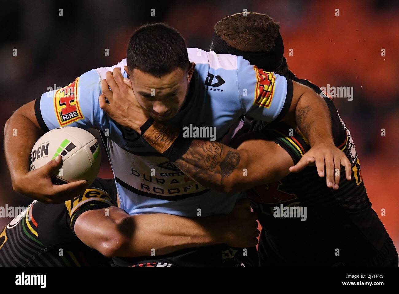 Braydon Trindall of the Sharks is tackled by Isaah Yeo and James Fisher ...