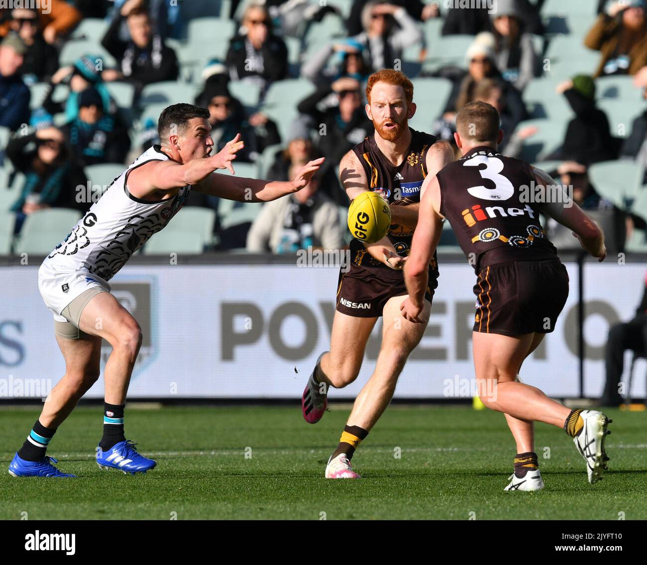 Conor Glass of the Hawks handballs during the Round 13 AFL match ...