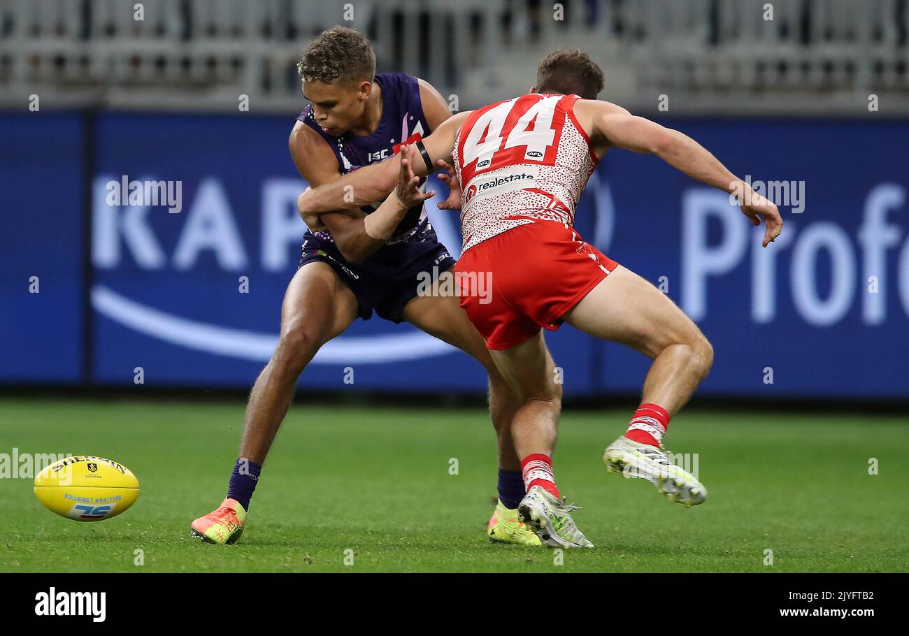 Liam Henry of the Dockers gathers the ball under pressure from Jake ...