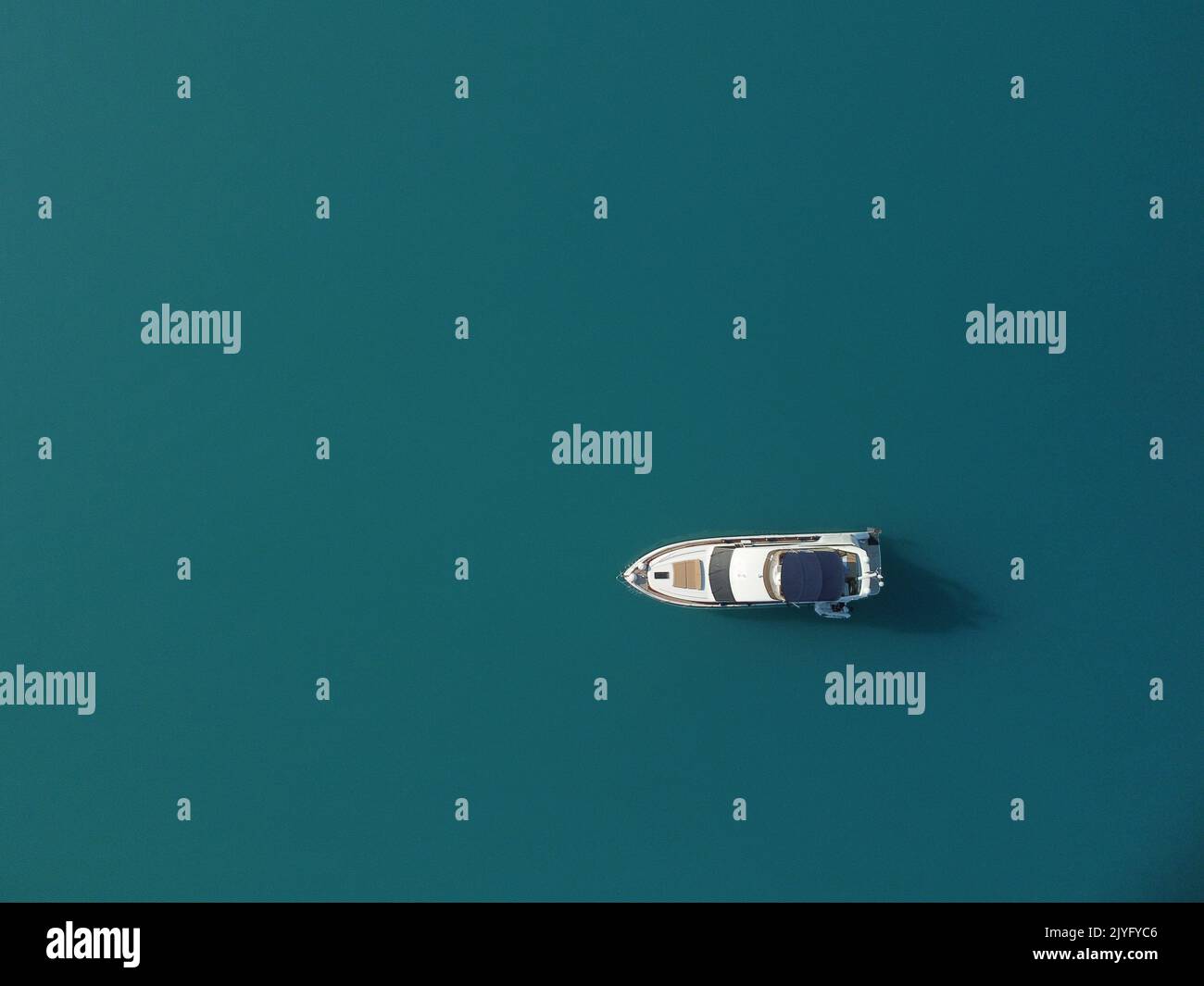 Aerial yacht on calm sea. Luxury cruise trip. View from above of white ...