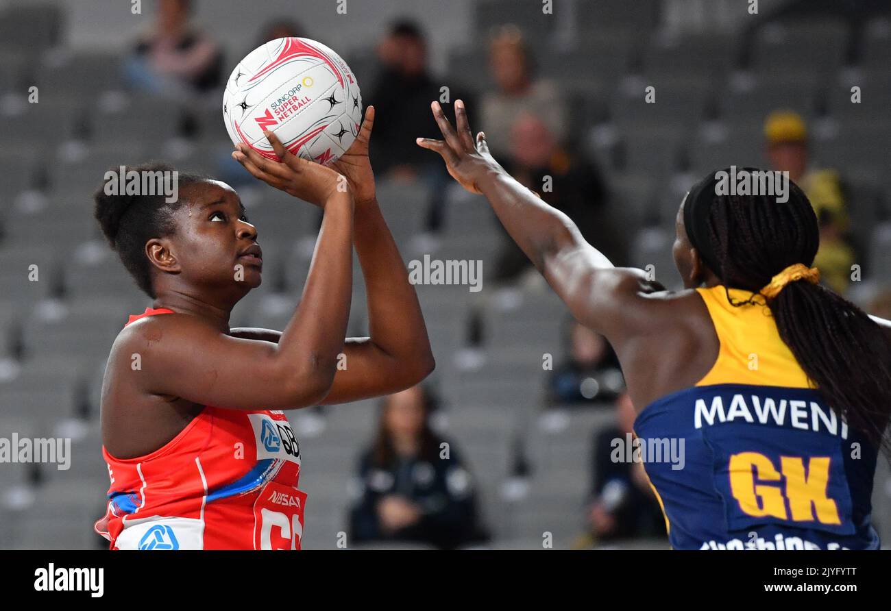 Sam Wallace (left) of the Swifts shoots for goal over Phumza Maweni ...