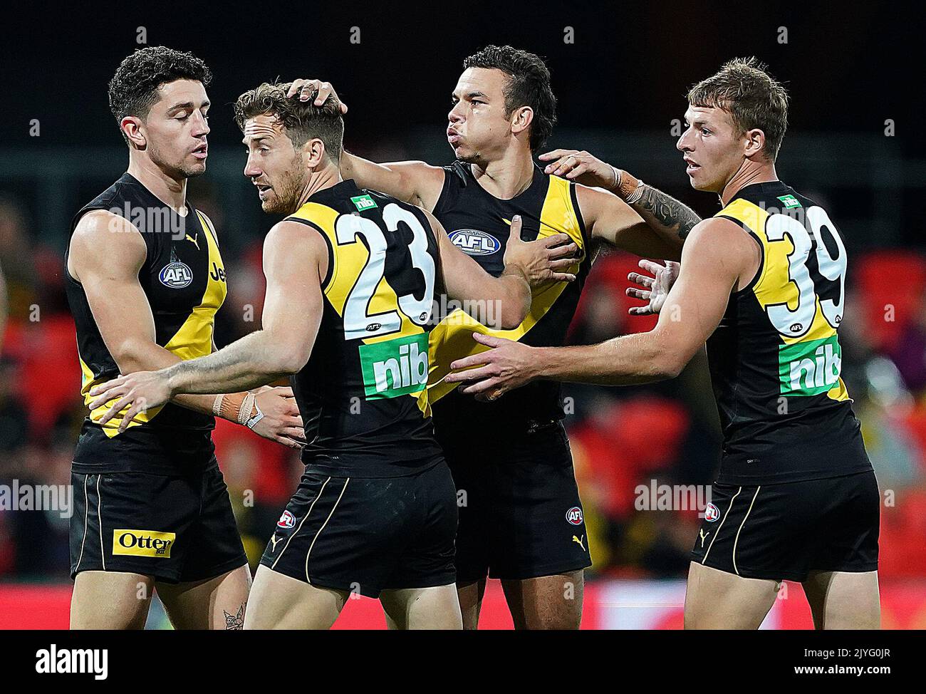 Daniel Rioli of the Tigers (centre) reactsafter kicking a goal during ...
