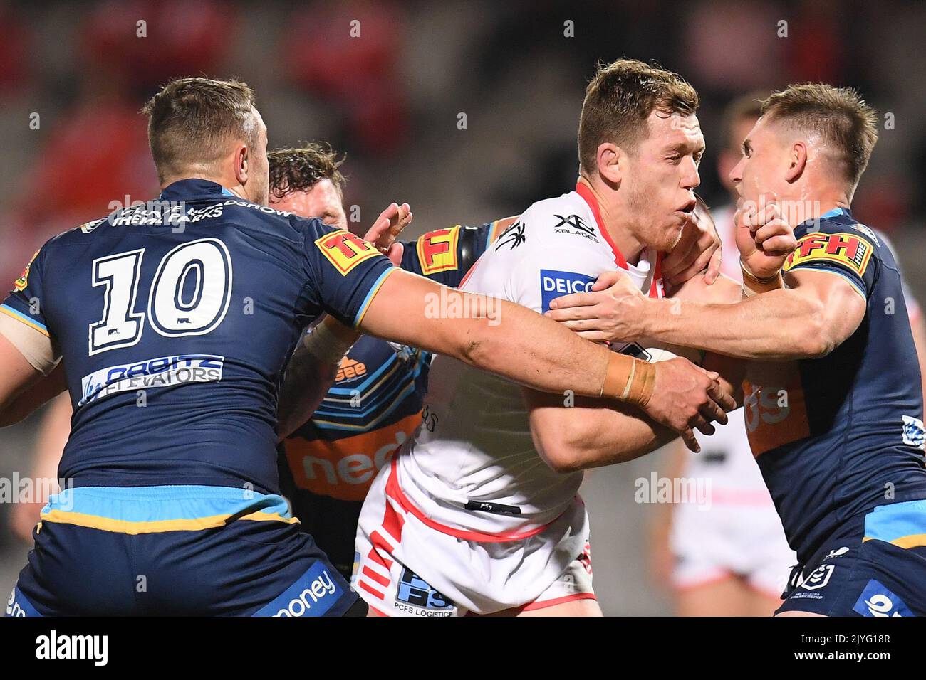 Cameron McInnes of the Dragons is hell by the Titans defence during the ...