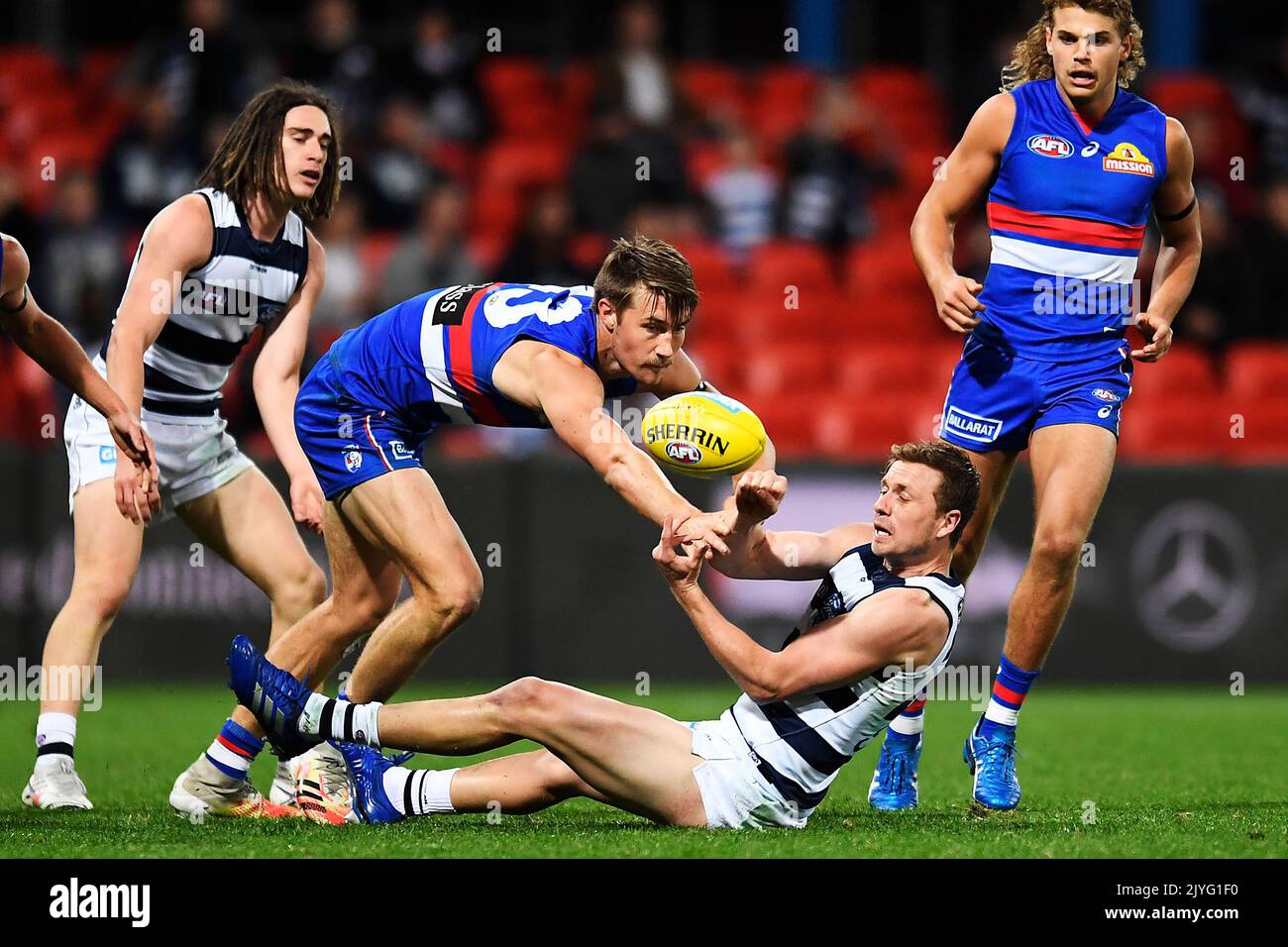 Mitch Duncan of the Cats handballs under pressure during the round 14 ...